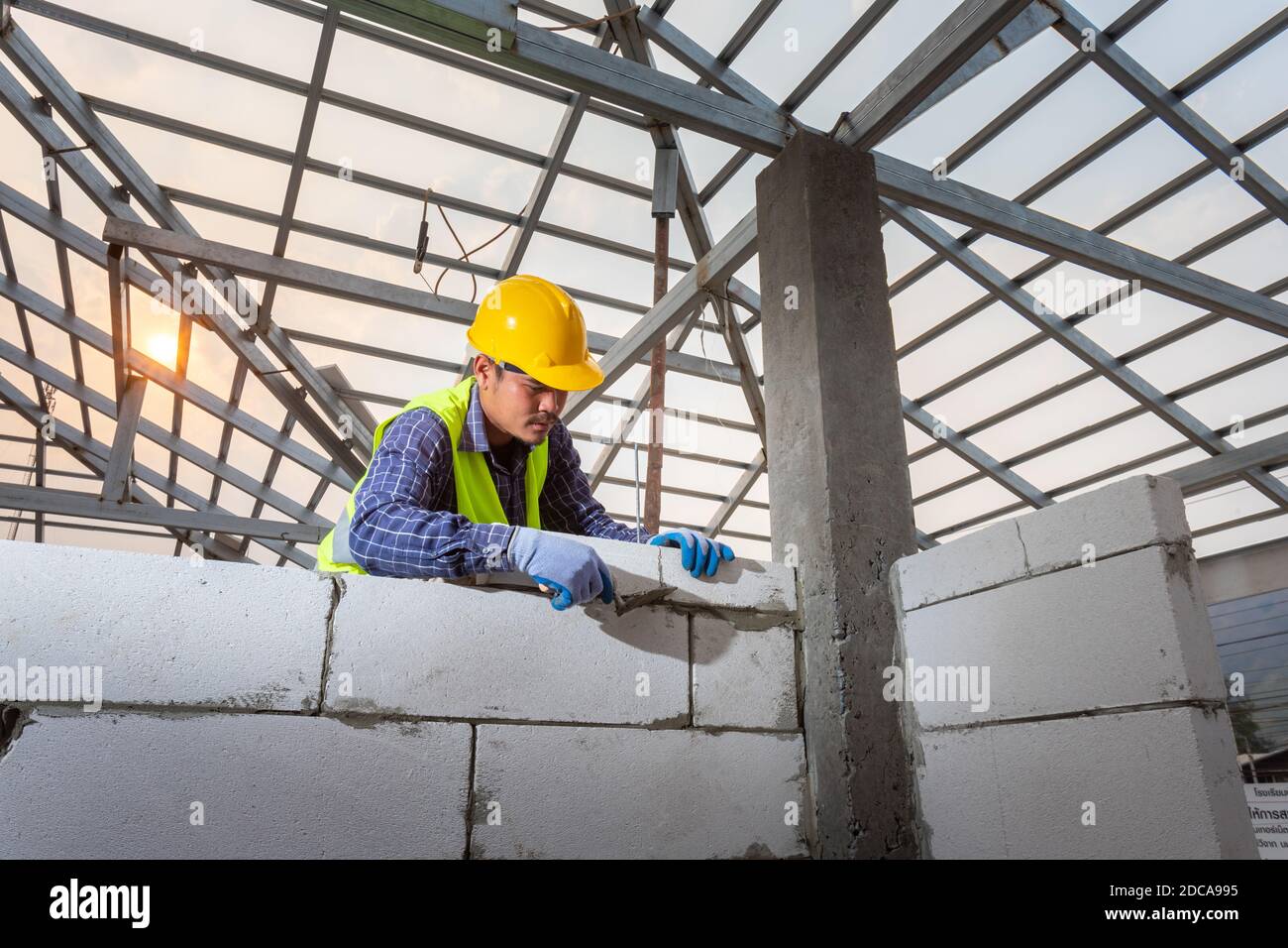 Asain worker bricklayer builder working with autoclaved aerated ...