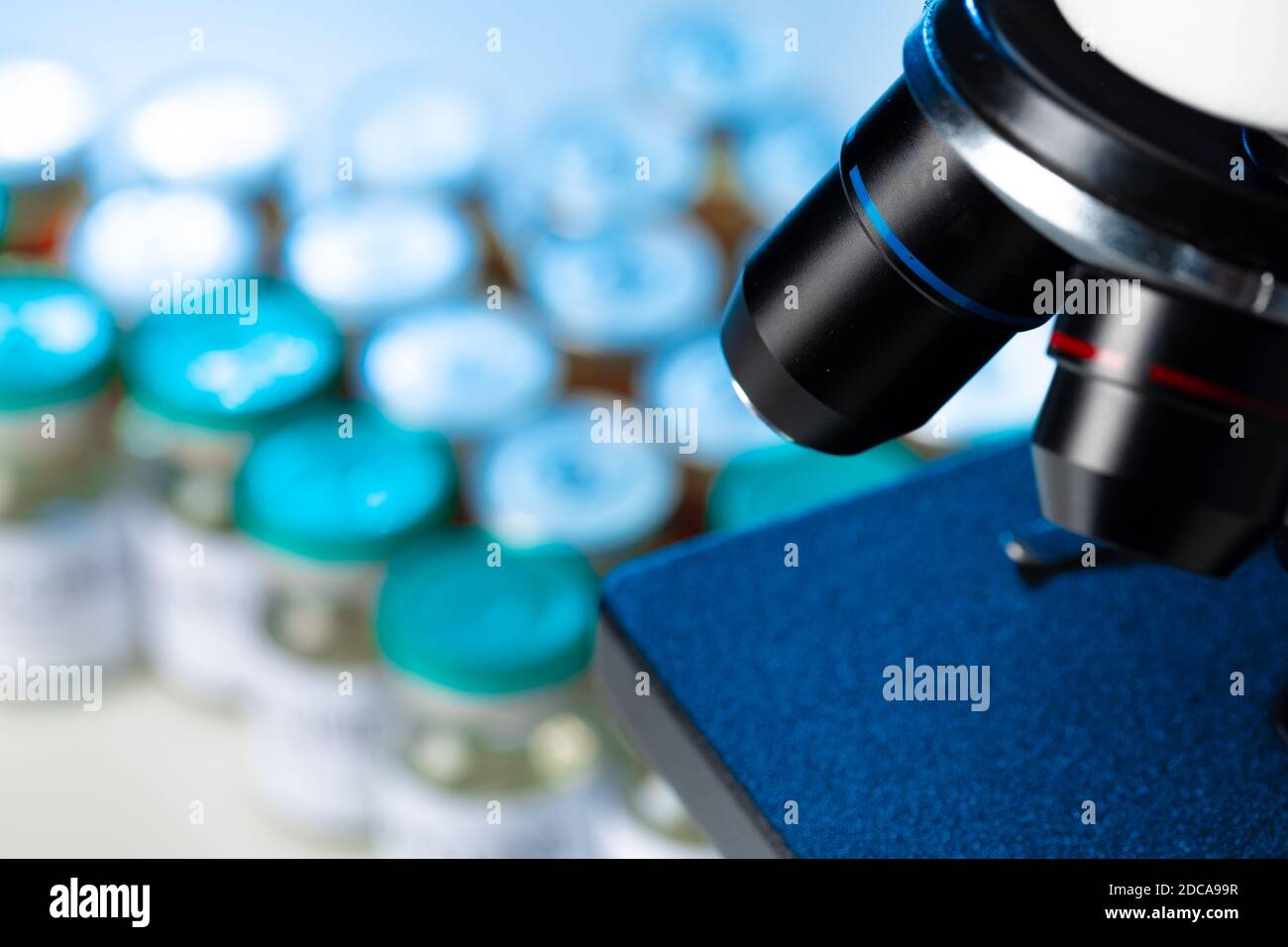 Medical vial with medication near microscope close up Stock Photo - Alamy
