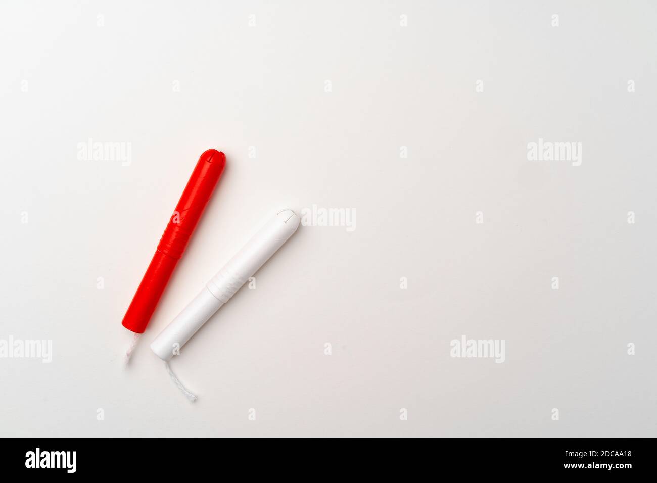 Red and white woman medical tampons on white background Stock Photo - Alamy