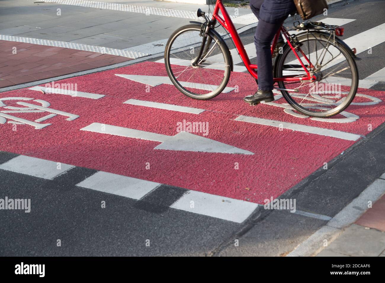 red painted two direction cycle lane Stock Photo - Alamy