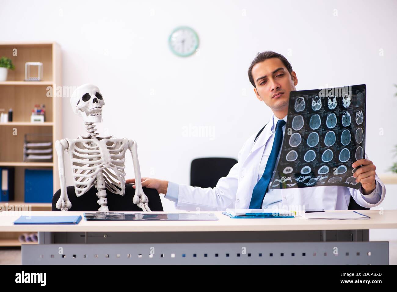 Young doctor radiologist and skeleton patient in the clinic Stock Photo ...