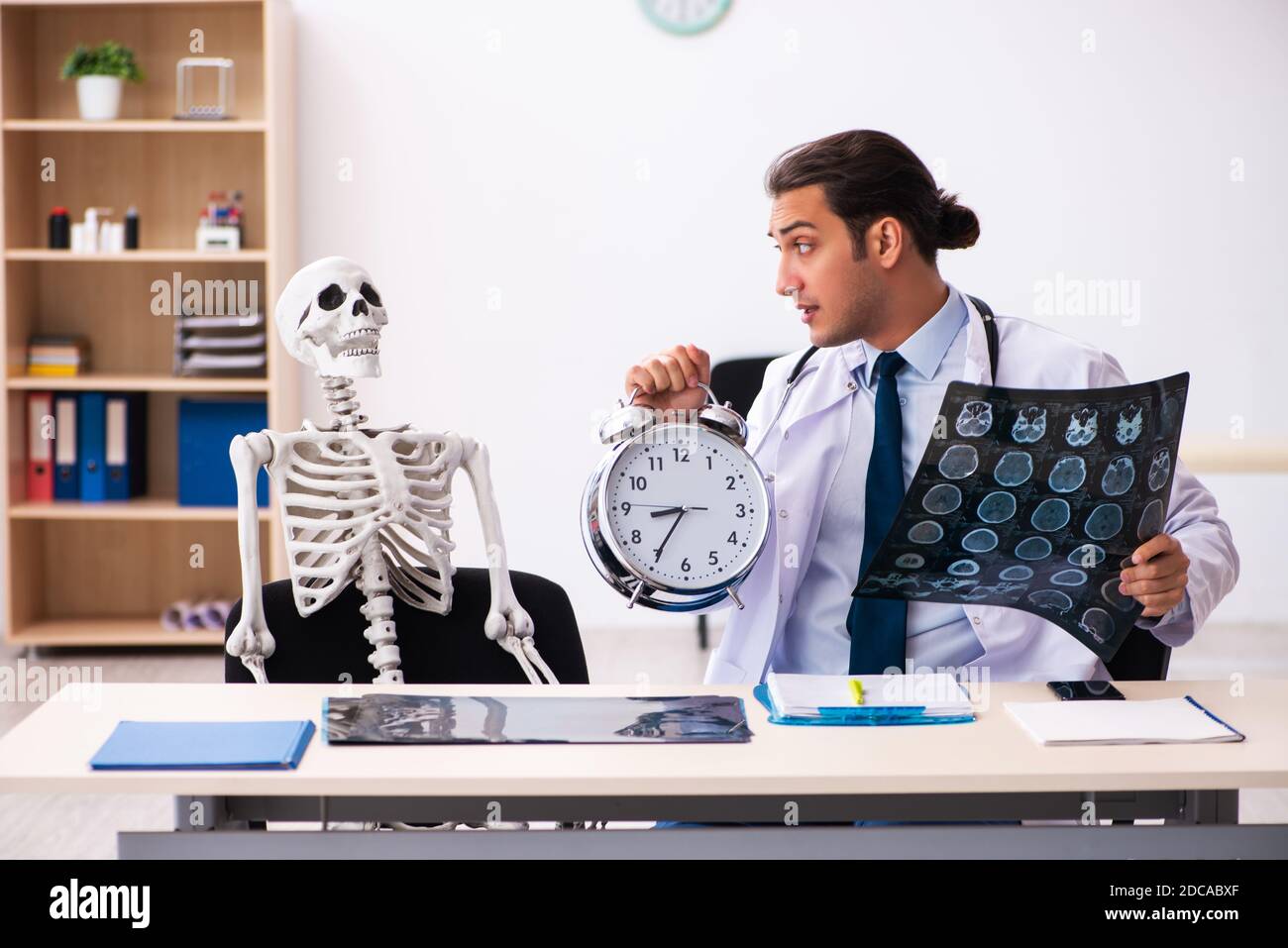 Young doctor radiologist and skeleton patient in the clinic Stock Photo ...