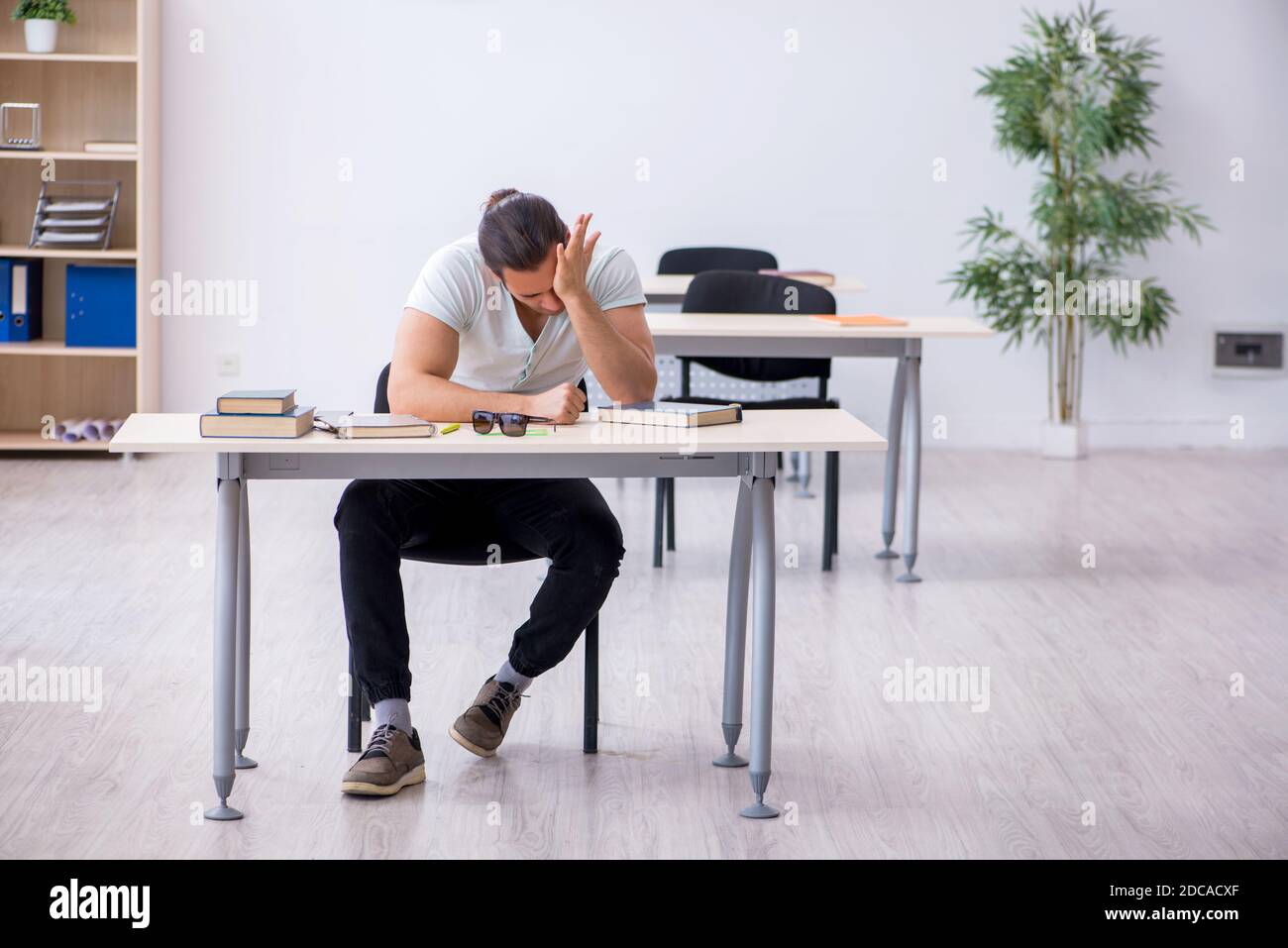 Young student preparing for exam in the classroom Stock Photo - Alamy