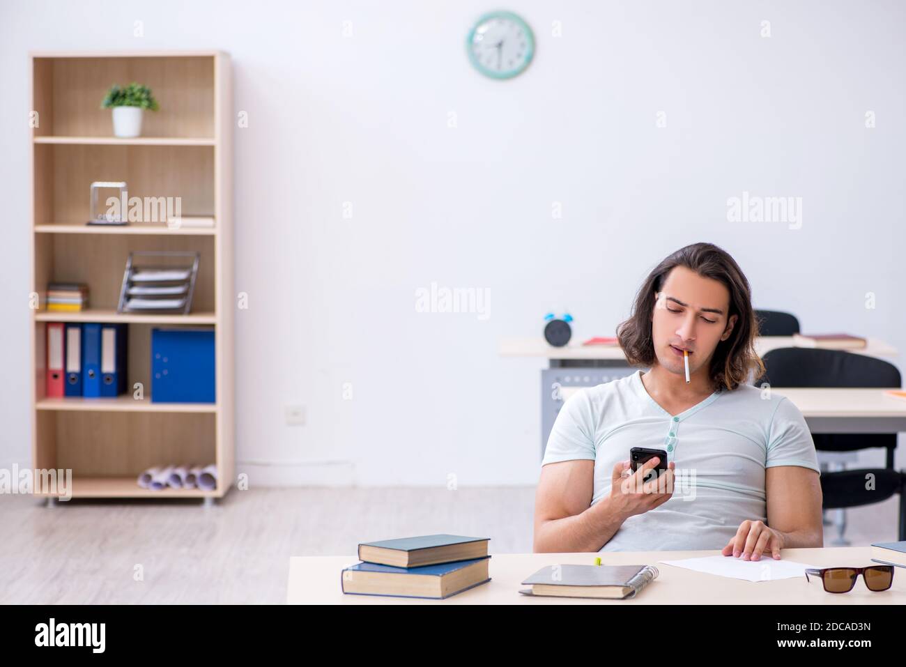 Male student smoking cigarettes in the classroom Stock Photo - Alamy