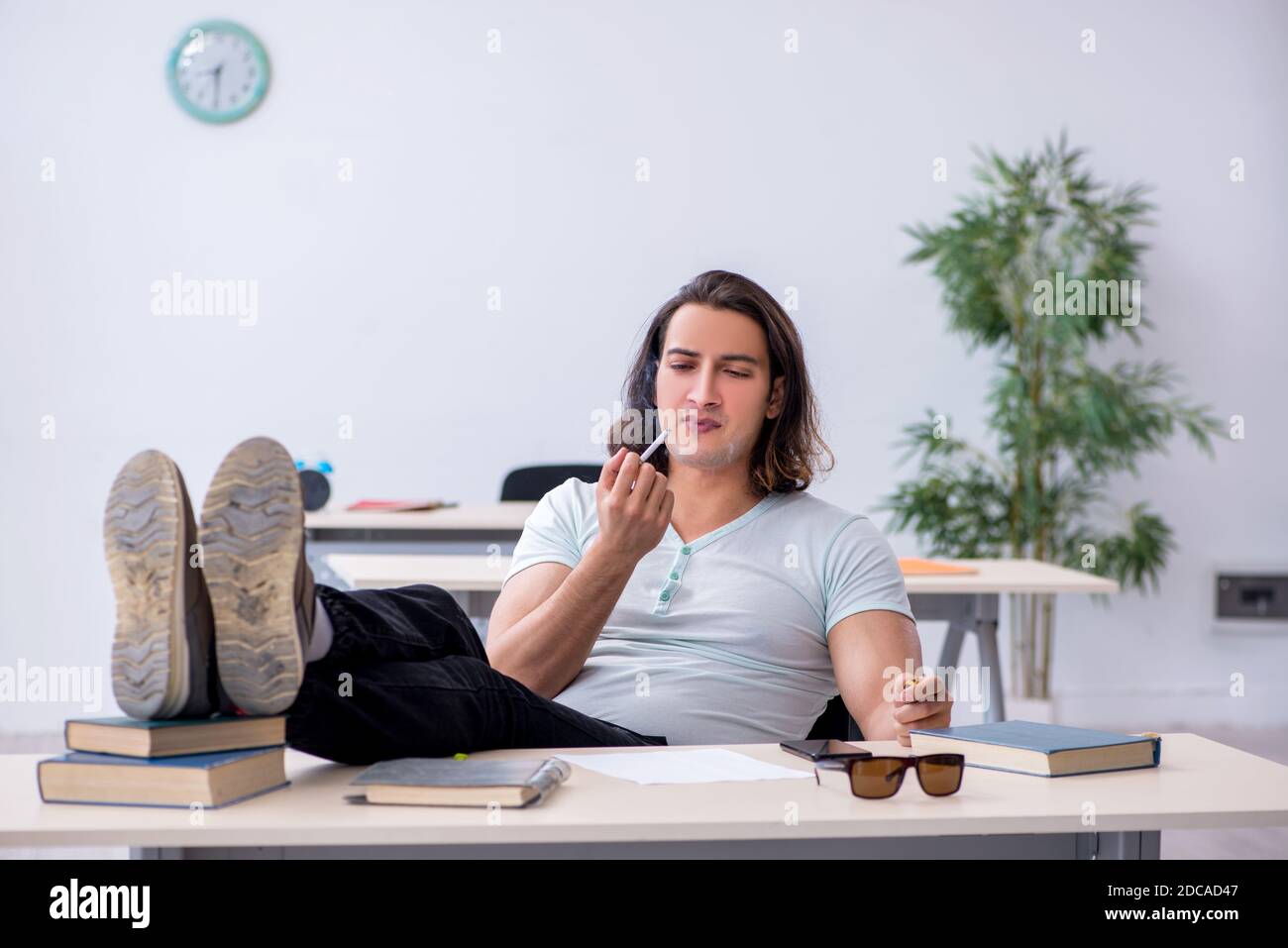 Male student smoking cigarettes in the classroom Stock Photo - Alamy