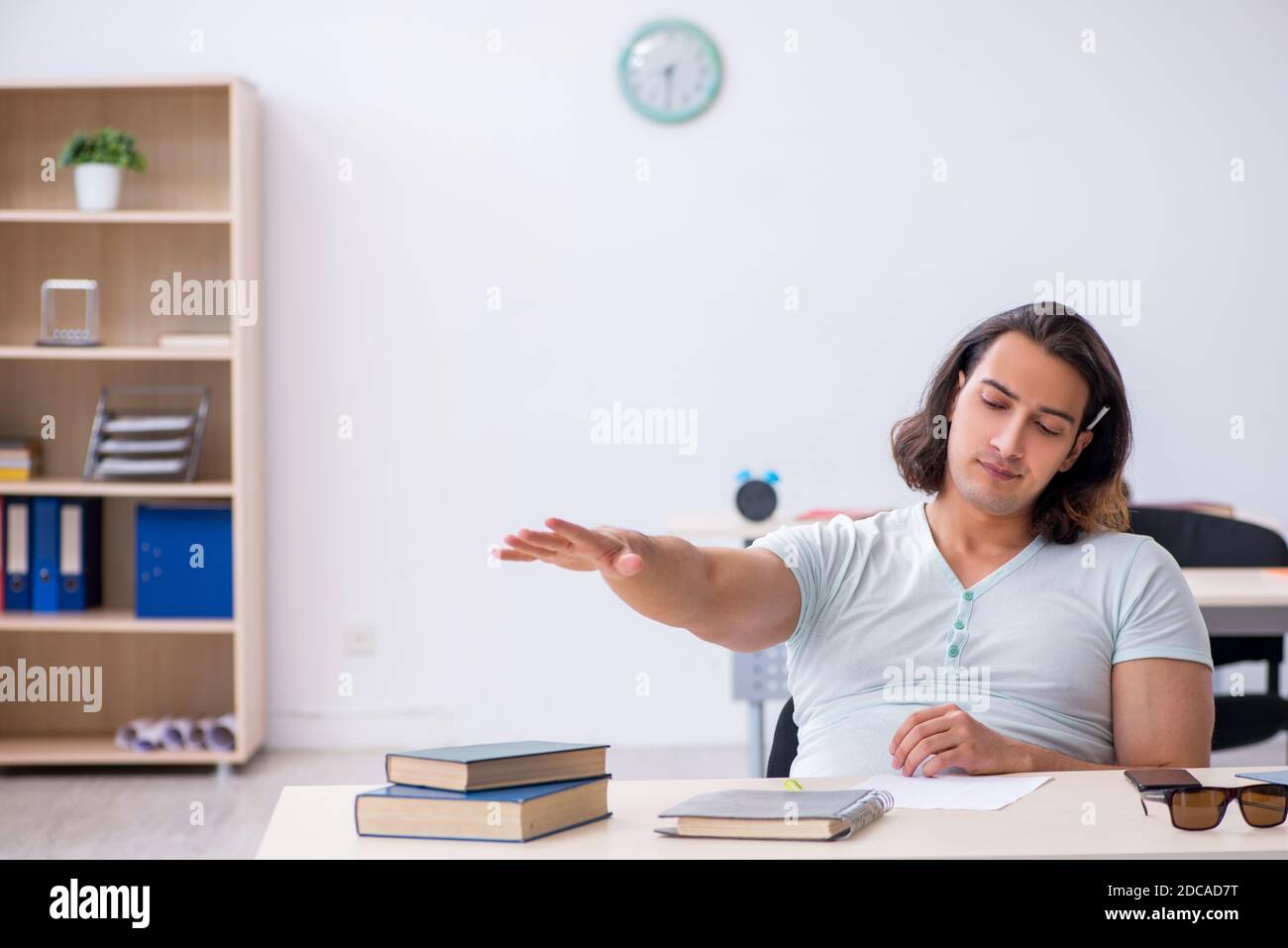 Young student preparing for exam in the classroom Stock Photo - Alamy