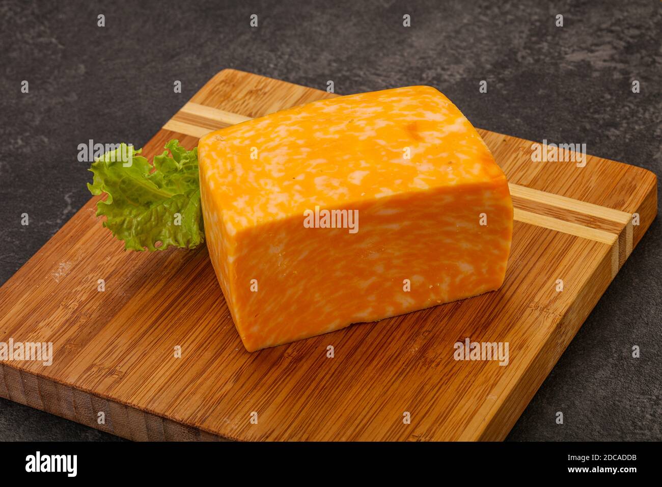 Dairy Marble cheese brick over board Stock Photo - Alamy