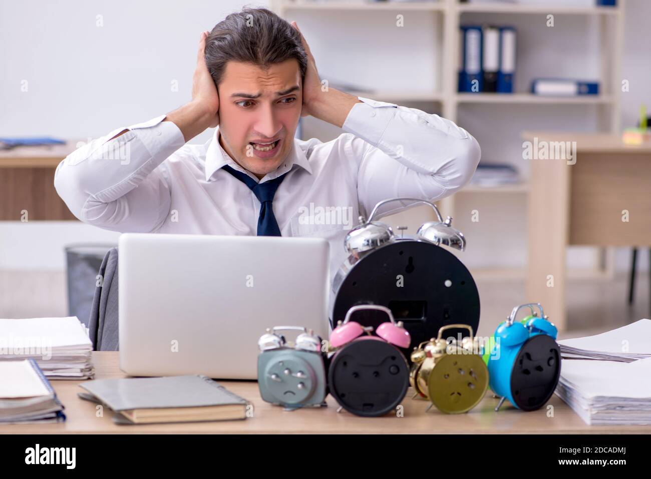 Young employee afraid of missing deadline at workplace Stock Photo - Alamy