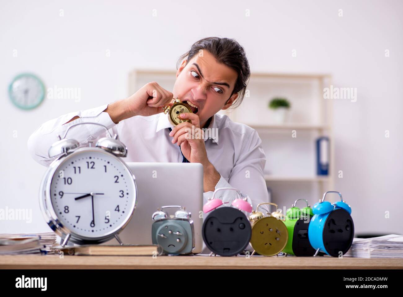 Young employee afraid of missing deadline at workplace Stock Photo - Alamy