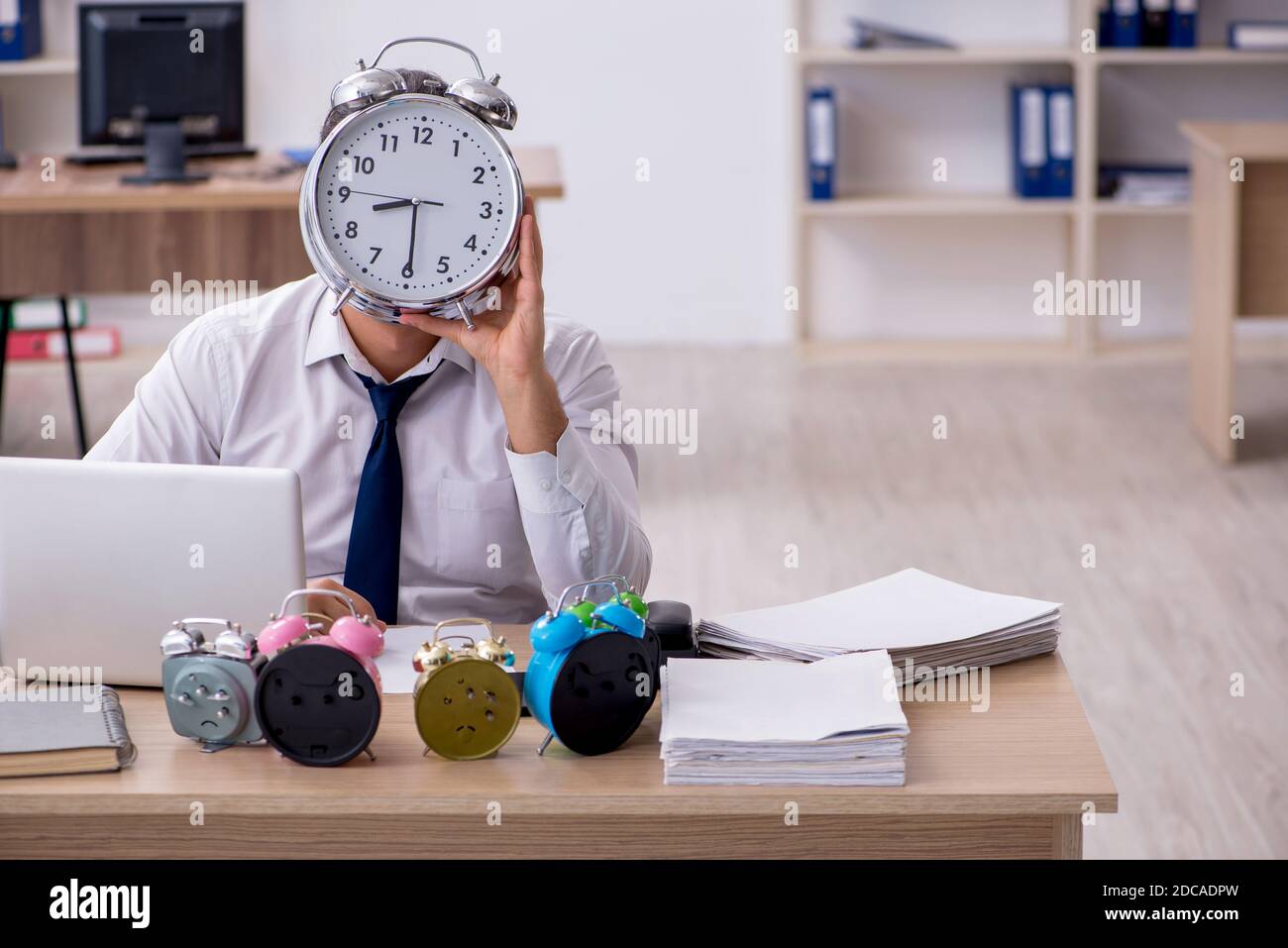 Young employee afraid of missing deadline at workplace Stock Photo - Alamy