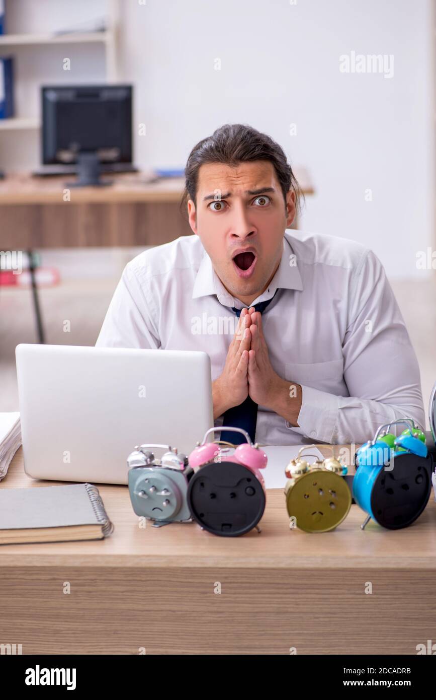 Young employee afraid of missing deadline at workplace Stock Photo - Alamy