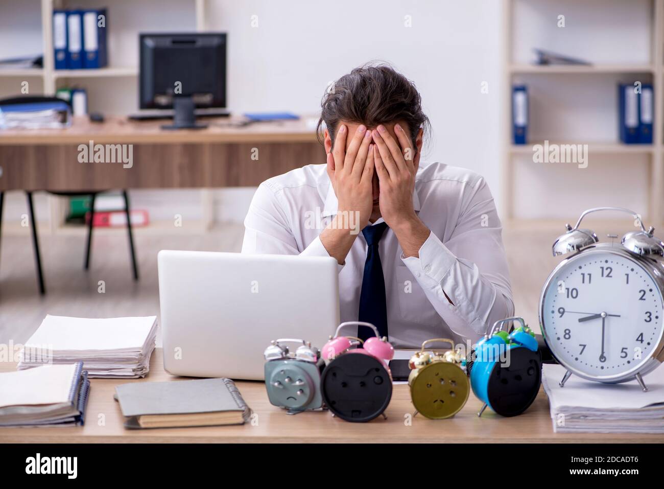 Young employee afraid of missing deadline at workplace Stock Photo - Alamy