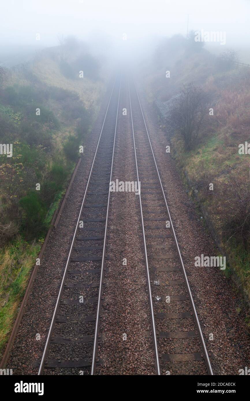 Train tacks disappearing into mist Stock Photo - Alamy