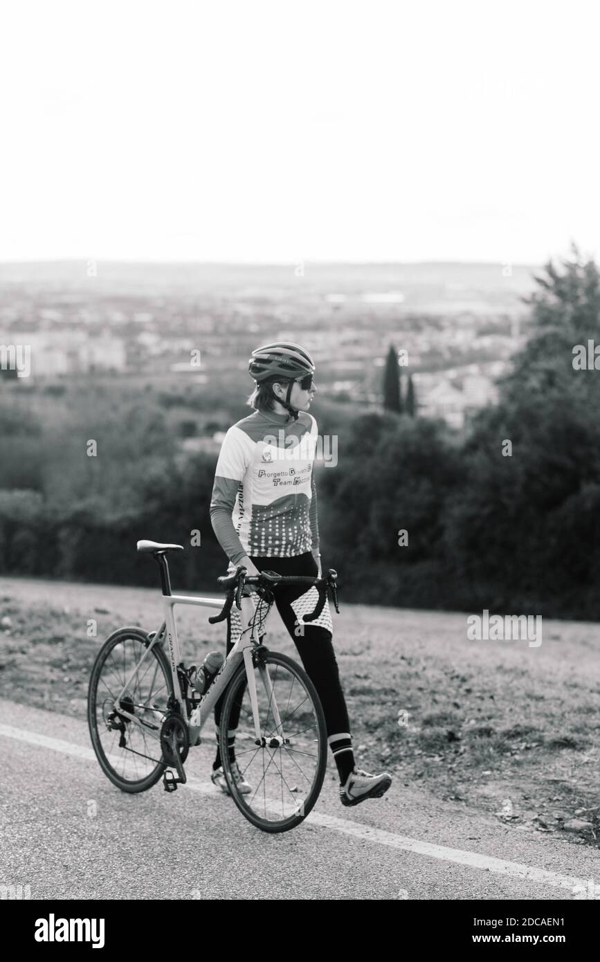 Professional cyclist riding racing bike in competition on open road ...