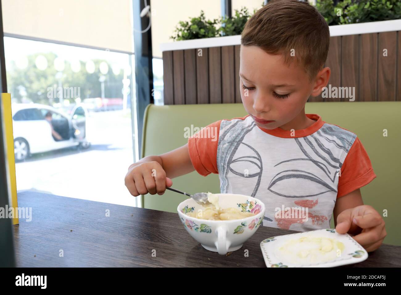 Boy eating Dumplings at table in a restaurant Stock Photo - Alamy