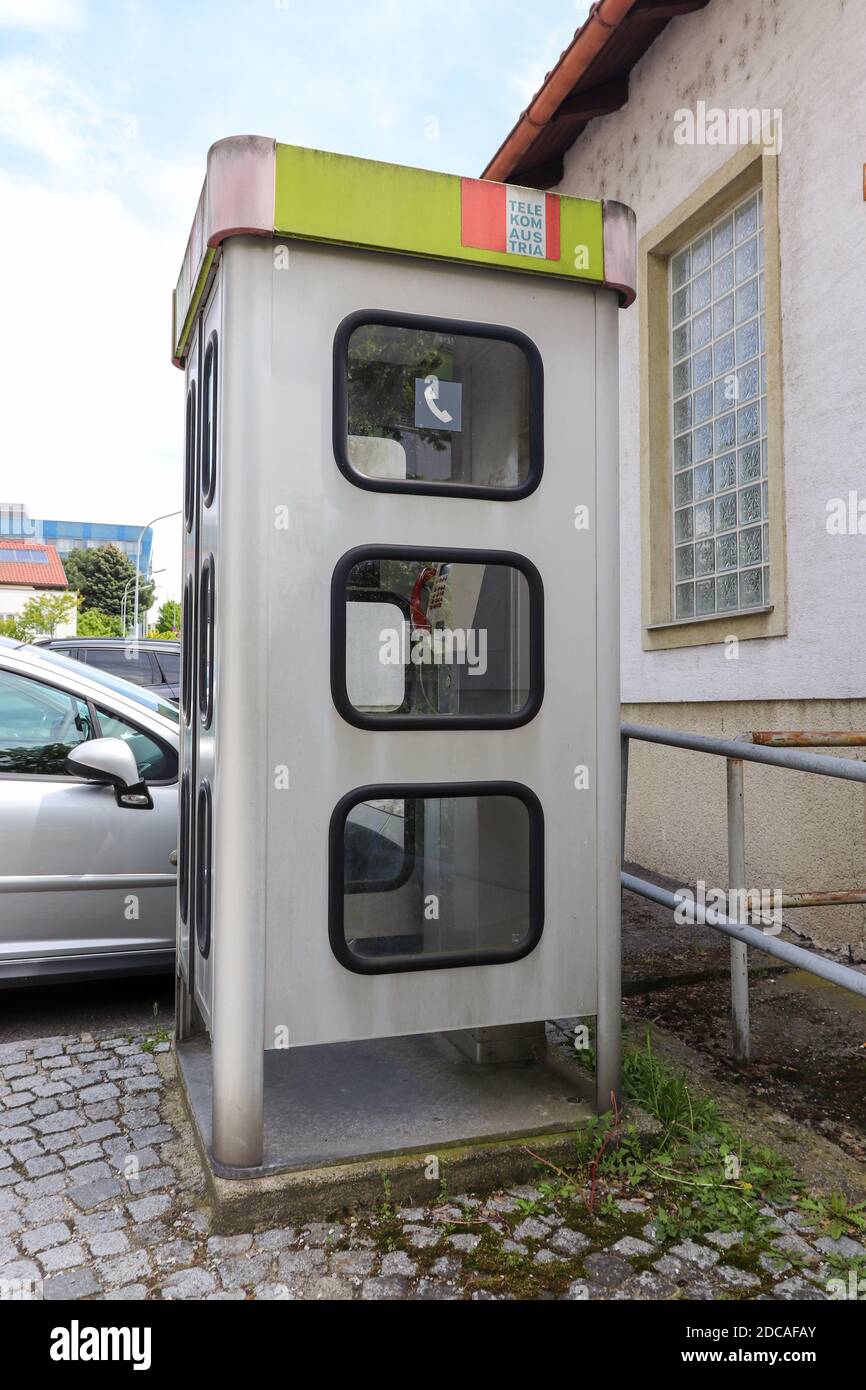 Windows on the side of a silver phone booth in Melk, Austria Stock ...