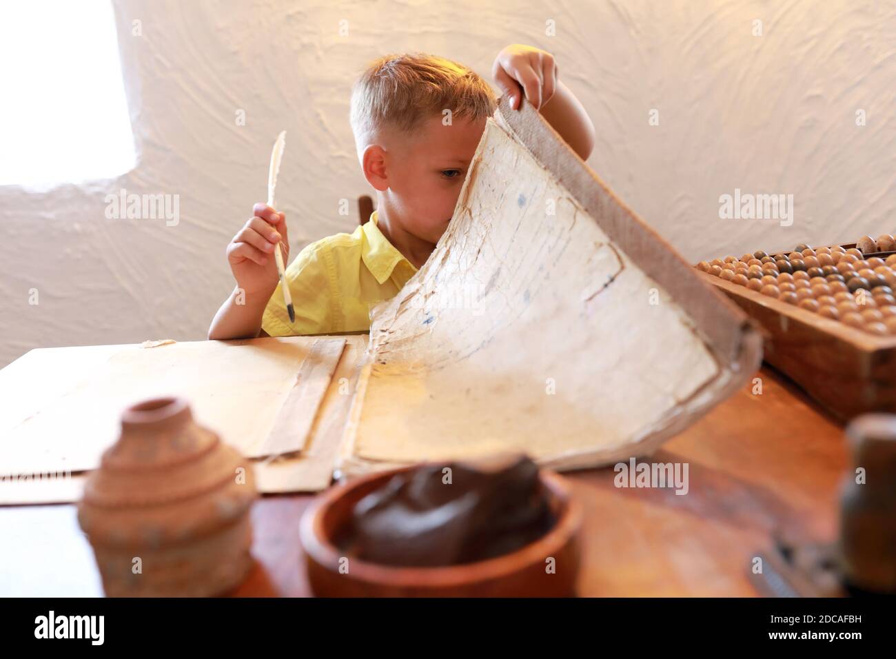 Boy writing with pen and ink hi-res stock photography and images - Alamy