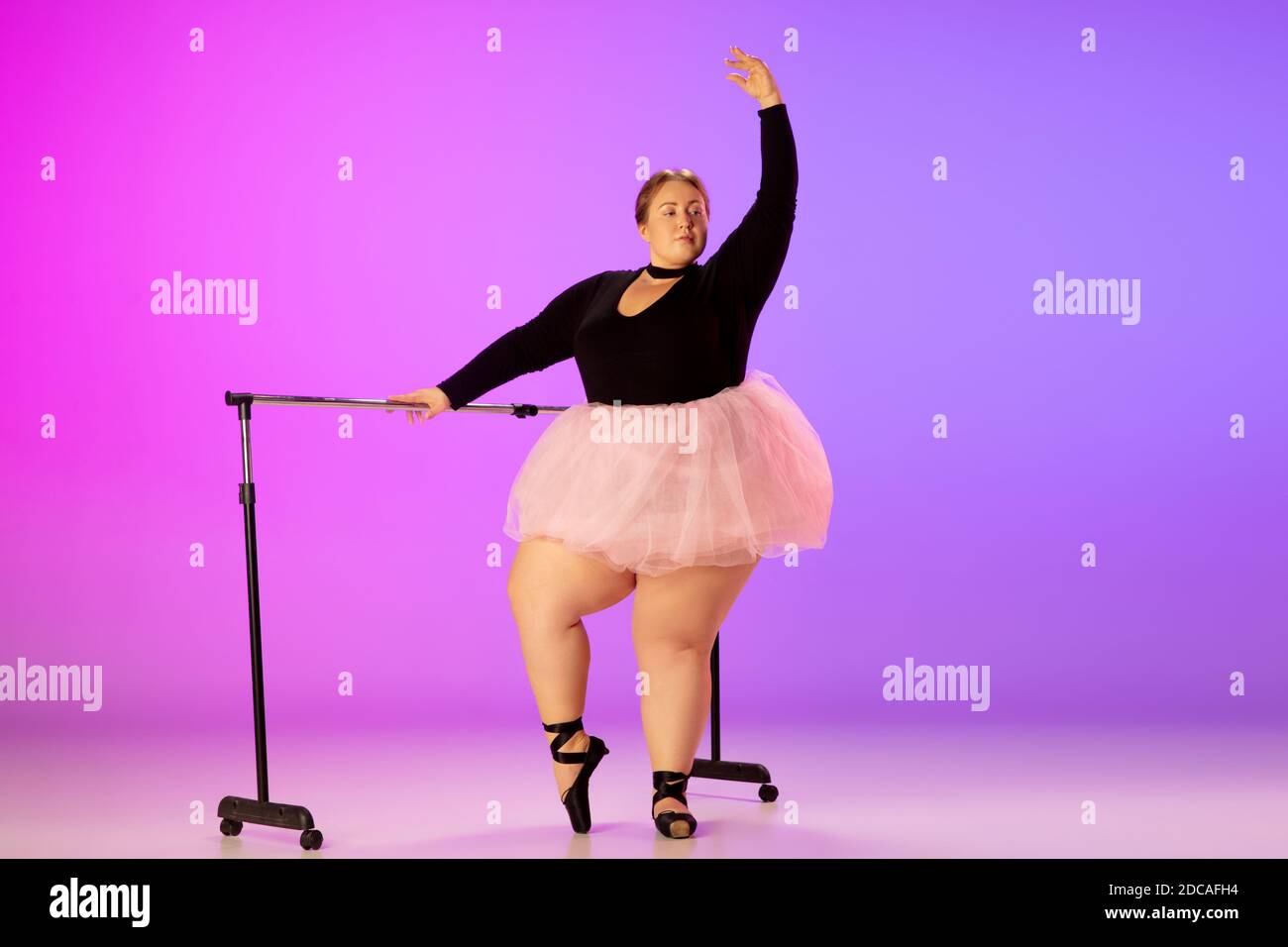 Graceful. Beautiful caucasian plus size model practicing ballet dance ...