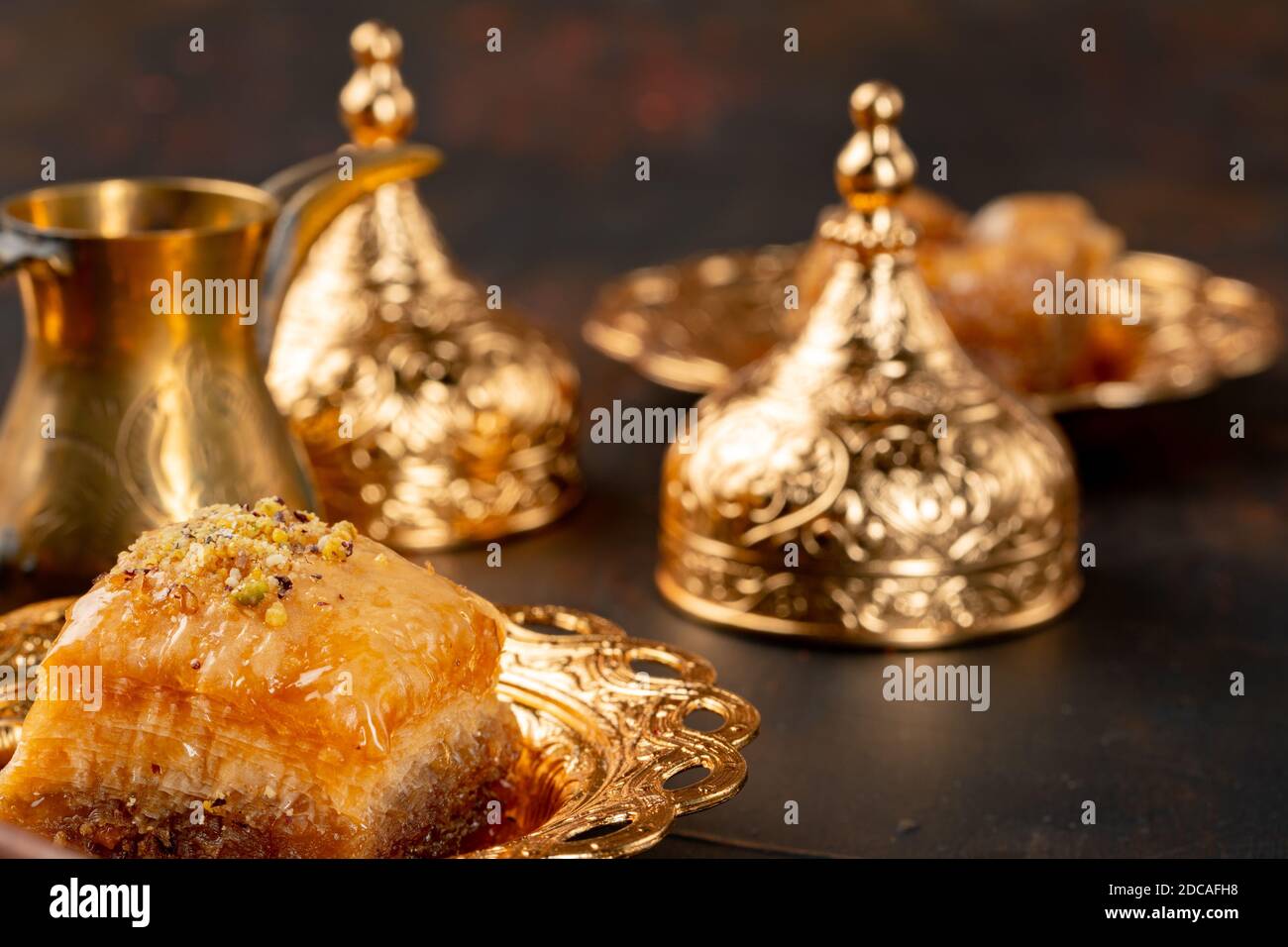Piece of Turkish baklava in golden arabic plate Stock Photo - Alamy