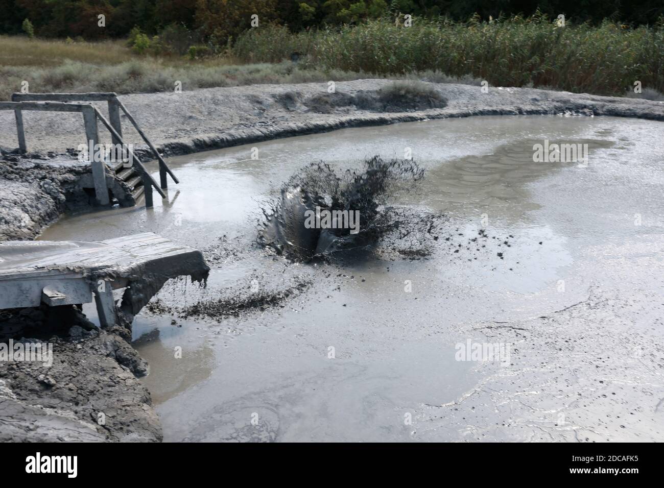 Person sliding on wooden mud hill into swamp Stock Photo - Alamy