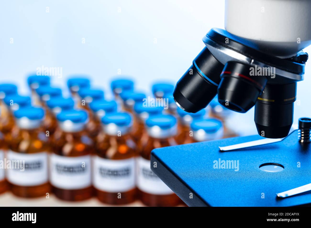 Medical vial with medication near microscope photo Stock Photo - Alamy