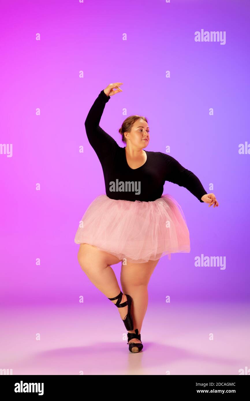 Confidence. Beautiful caucasian plus size model practicing ballet dance ...