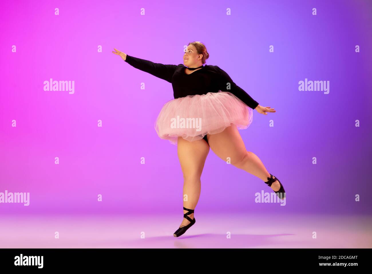 Confidence. Beautiful caucasian plus size model practicing ballet dance ...