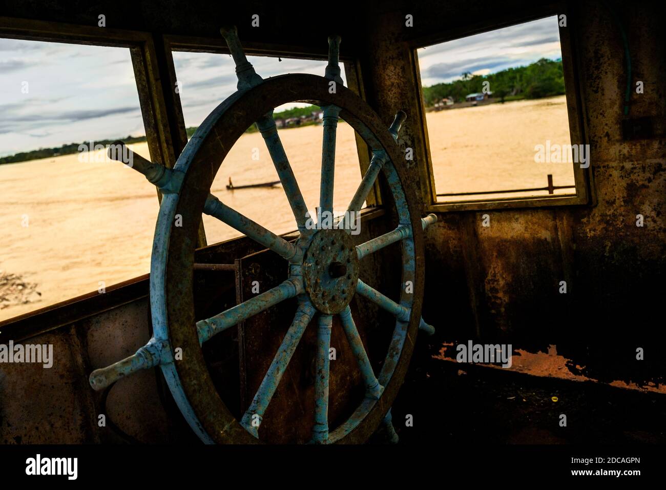 A large wooden steering wheel is seen on the captain’s bridge of an old ...