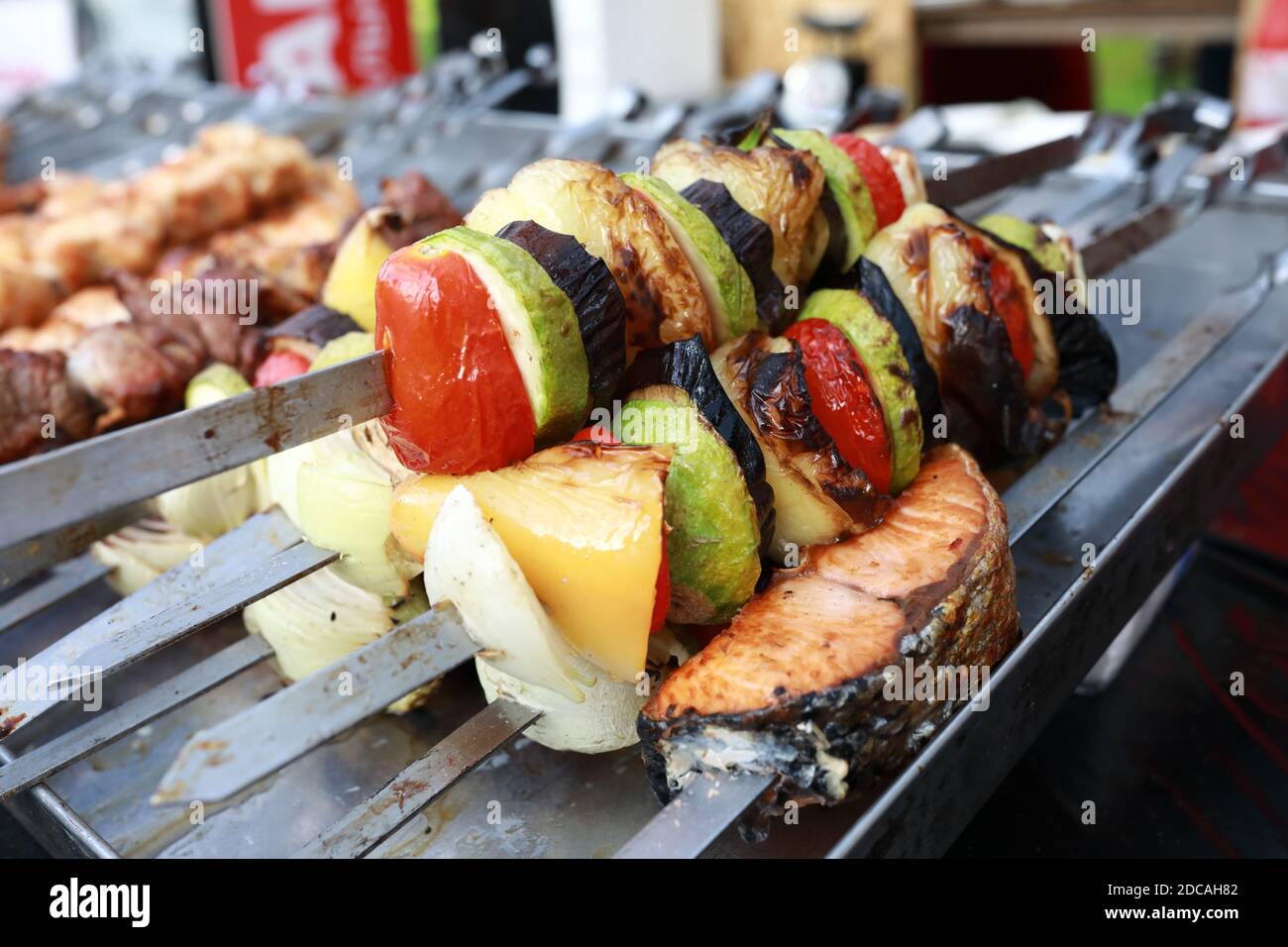 Various vegetable and fish kebab on skewers on market counter Stock ...