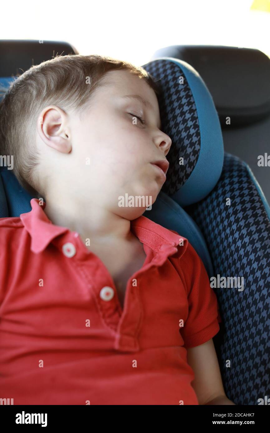 Portrait of kid sleeping in car seat Stock Photo - Alamy