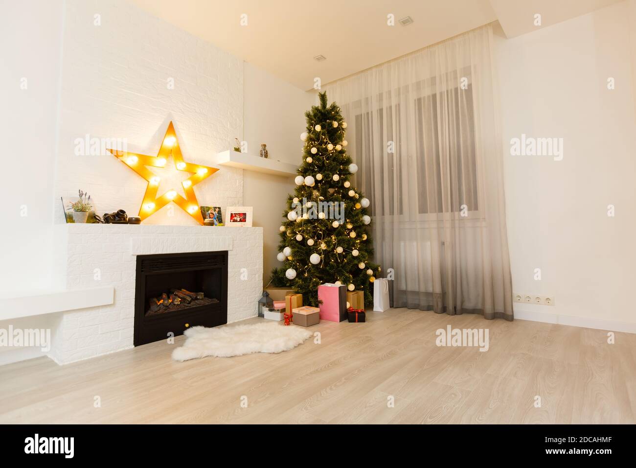 Christmas scene with tree gifts and fire in background Stock Photo - Alamy