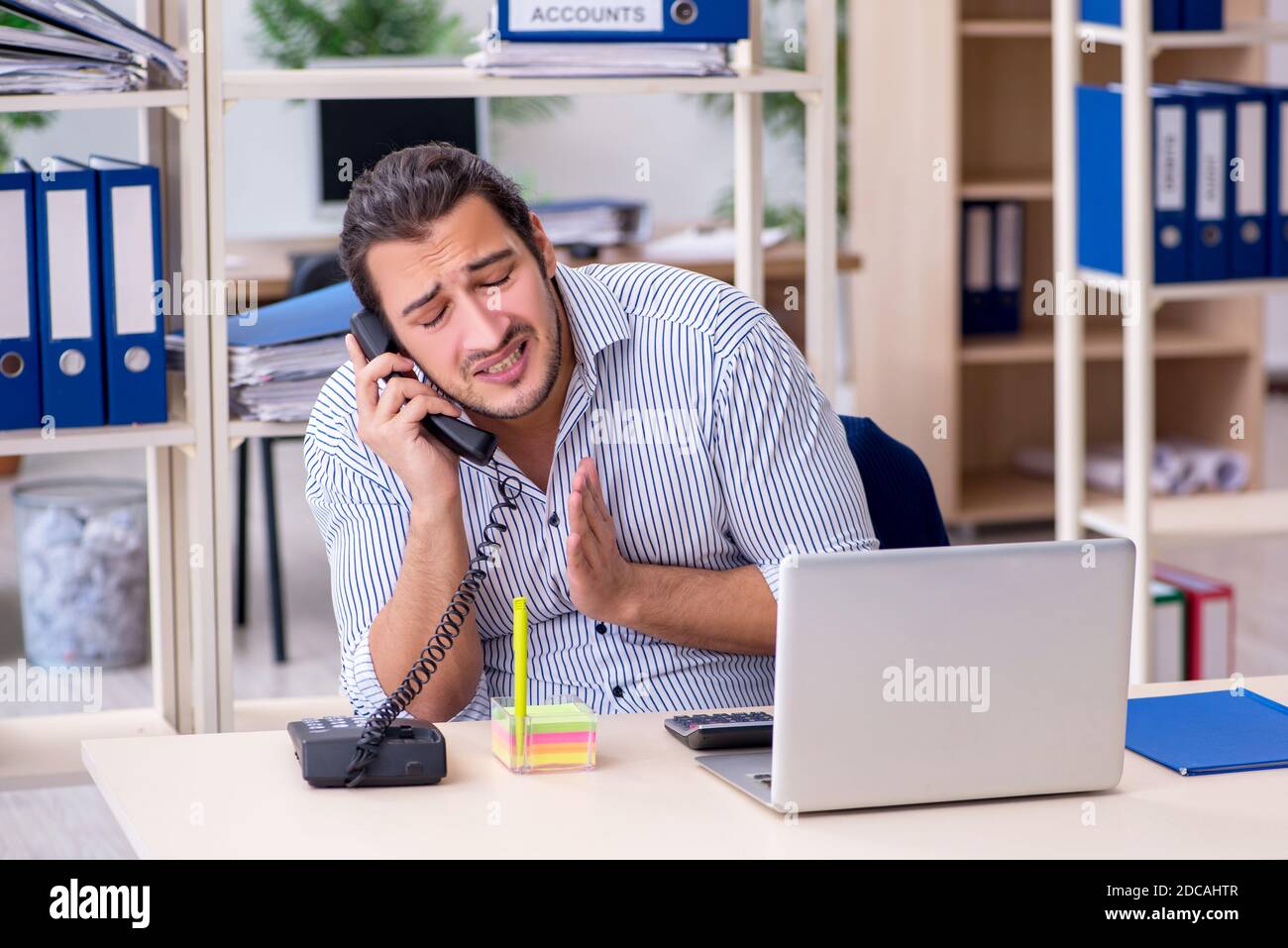 Hungry employee ordering food at workplace Stock Photo - Alamy