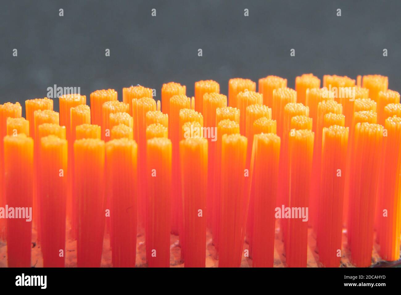 Orange toothbrush bristles close up Stock Photo - Alamy