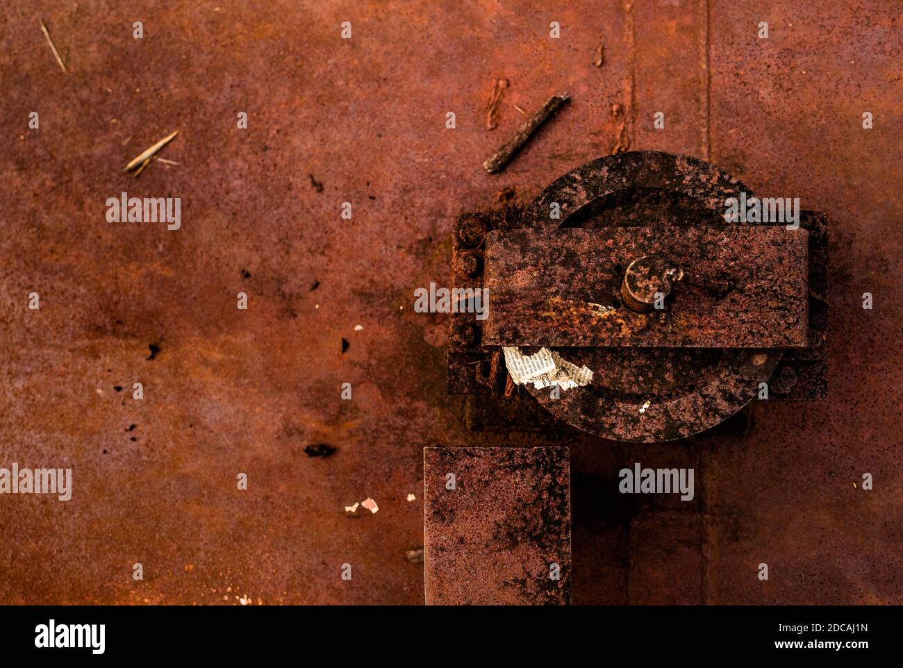 A corroded mechanical device is seen on the deck of an old gold dredge ...