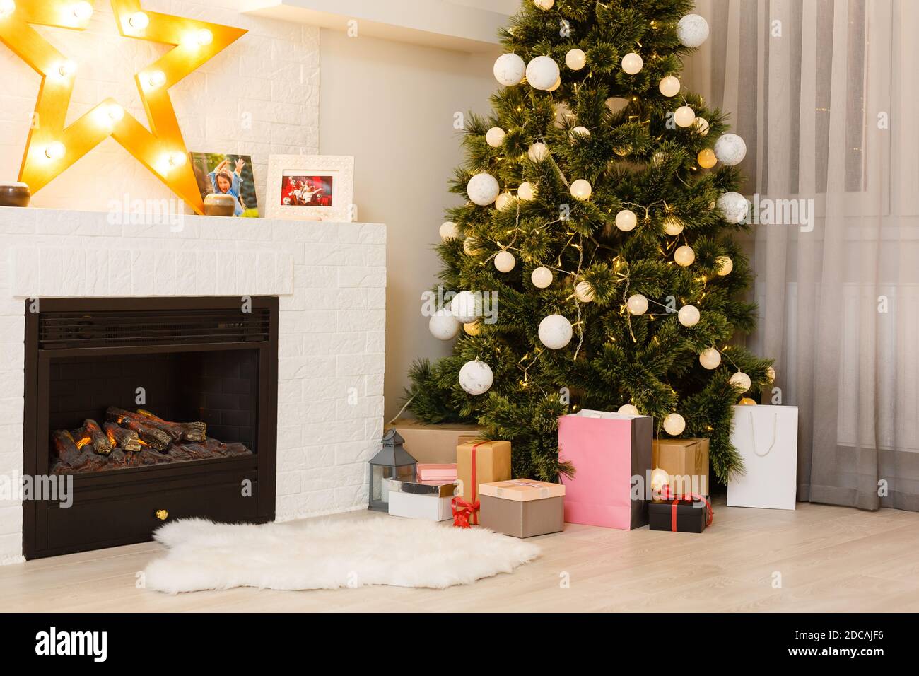 Christmas scene with tree gifts and fire in background Stock Photo - Alamy