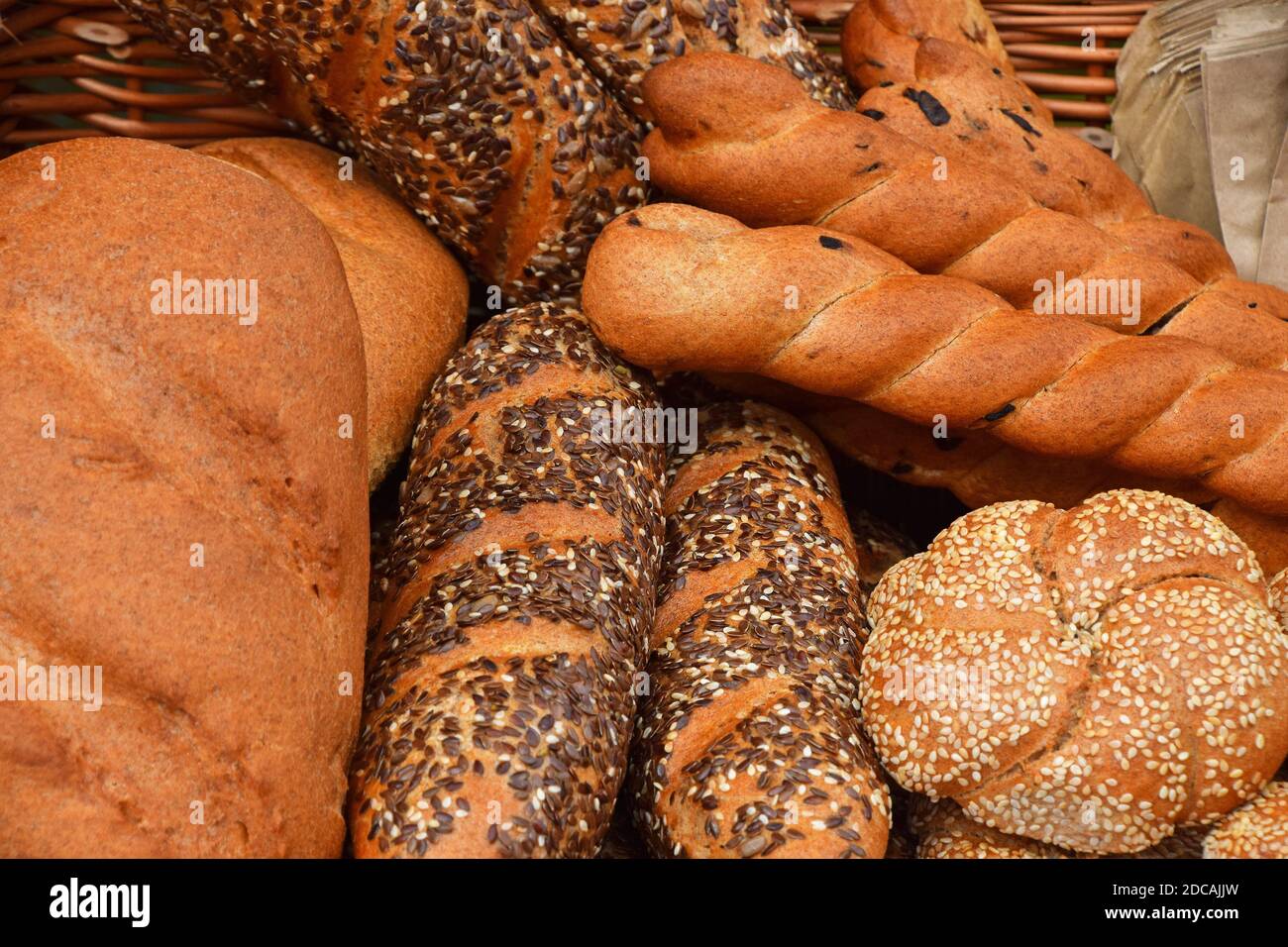 Close up several assorted fresh wheat bread buns, loaves and baguettes ...