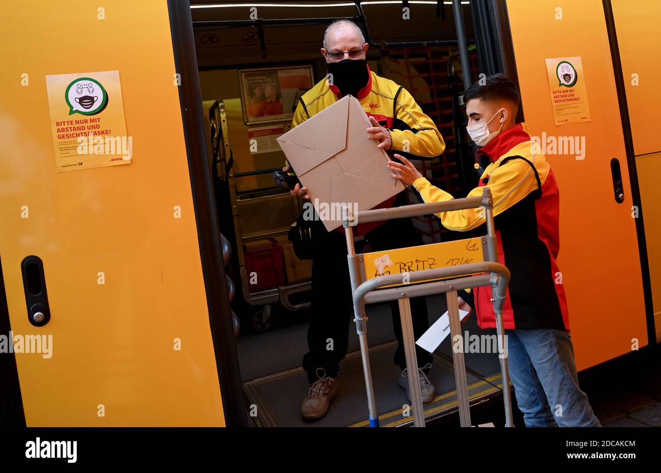 Berlin, Germany. 18th Nov, 2020. DHL employees deliver packages to the ...