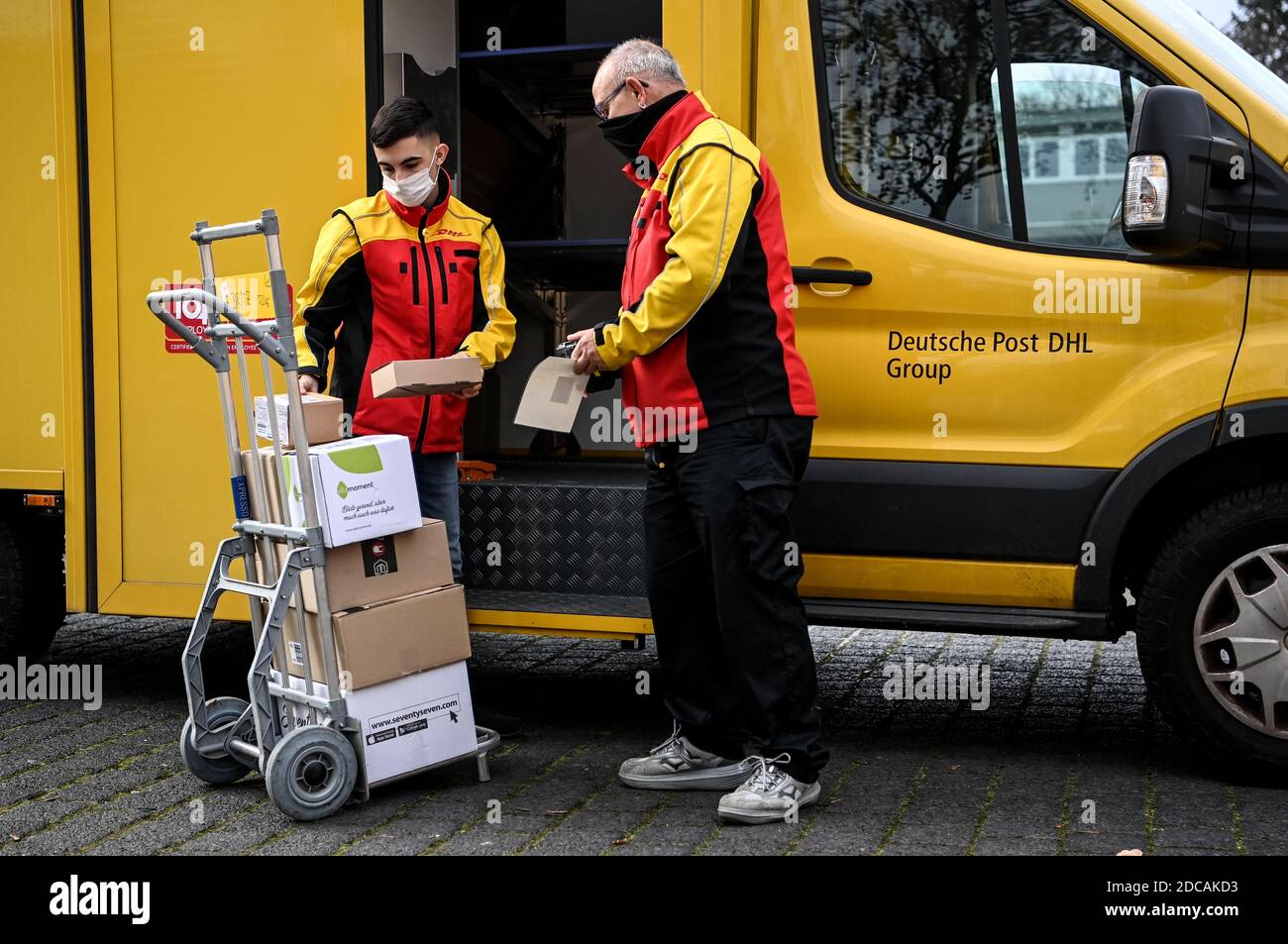 Berlin, Germany. 18th Nov, 2020. DHL employees deliver packages to the ...