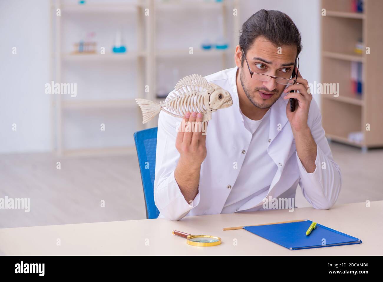 Young zoologist student studying fish skeleton Stock Photo - Alamy