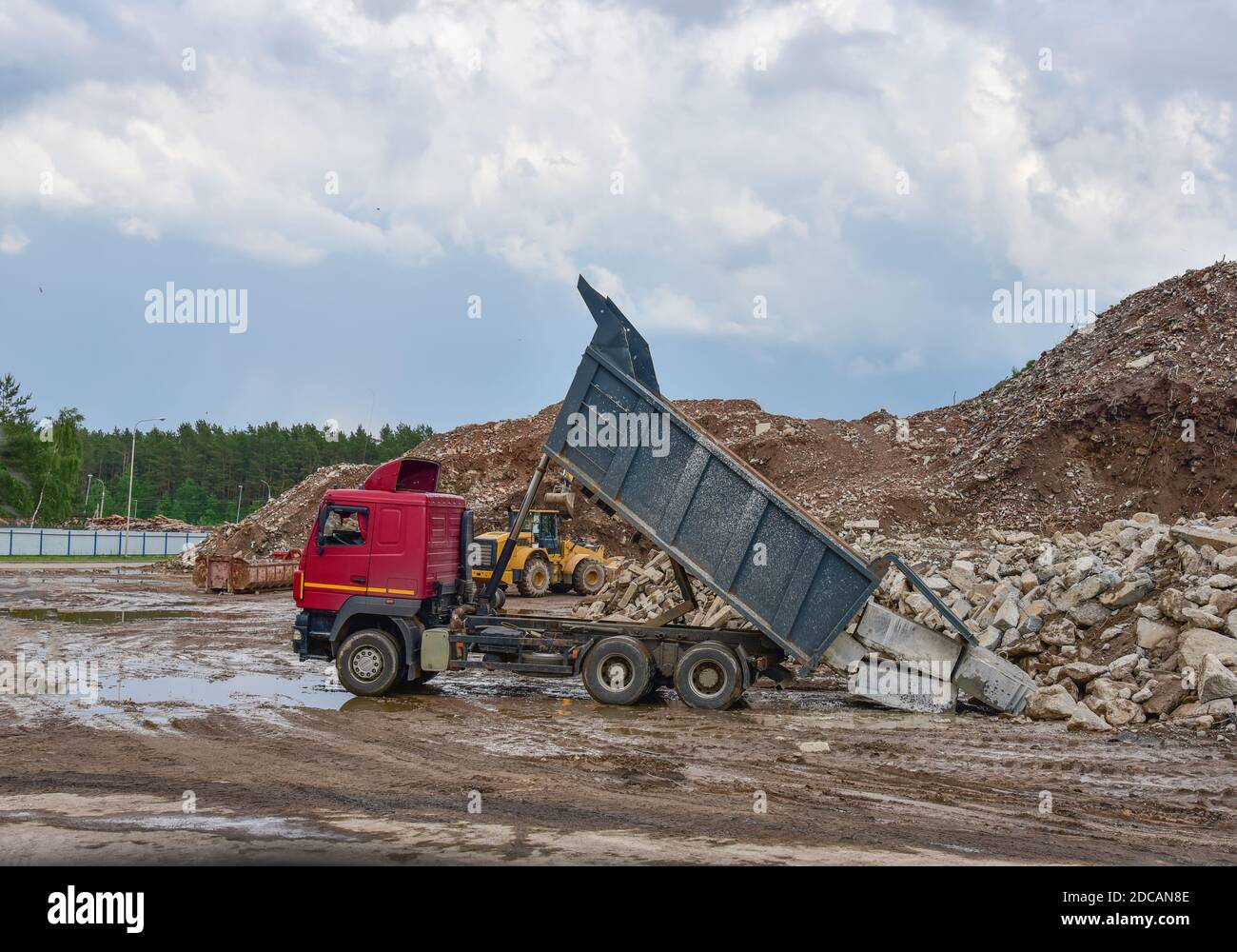 Dump truck unloading old concrete and asphalt from demolition for ...