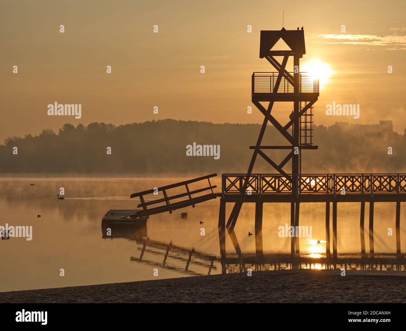 Pier tower at the Pogoria III Lake during sunrise Stock Photo - Alamy