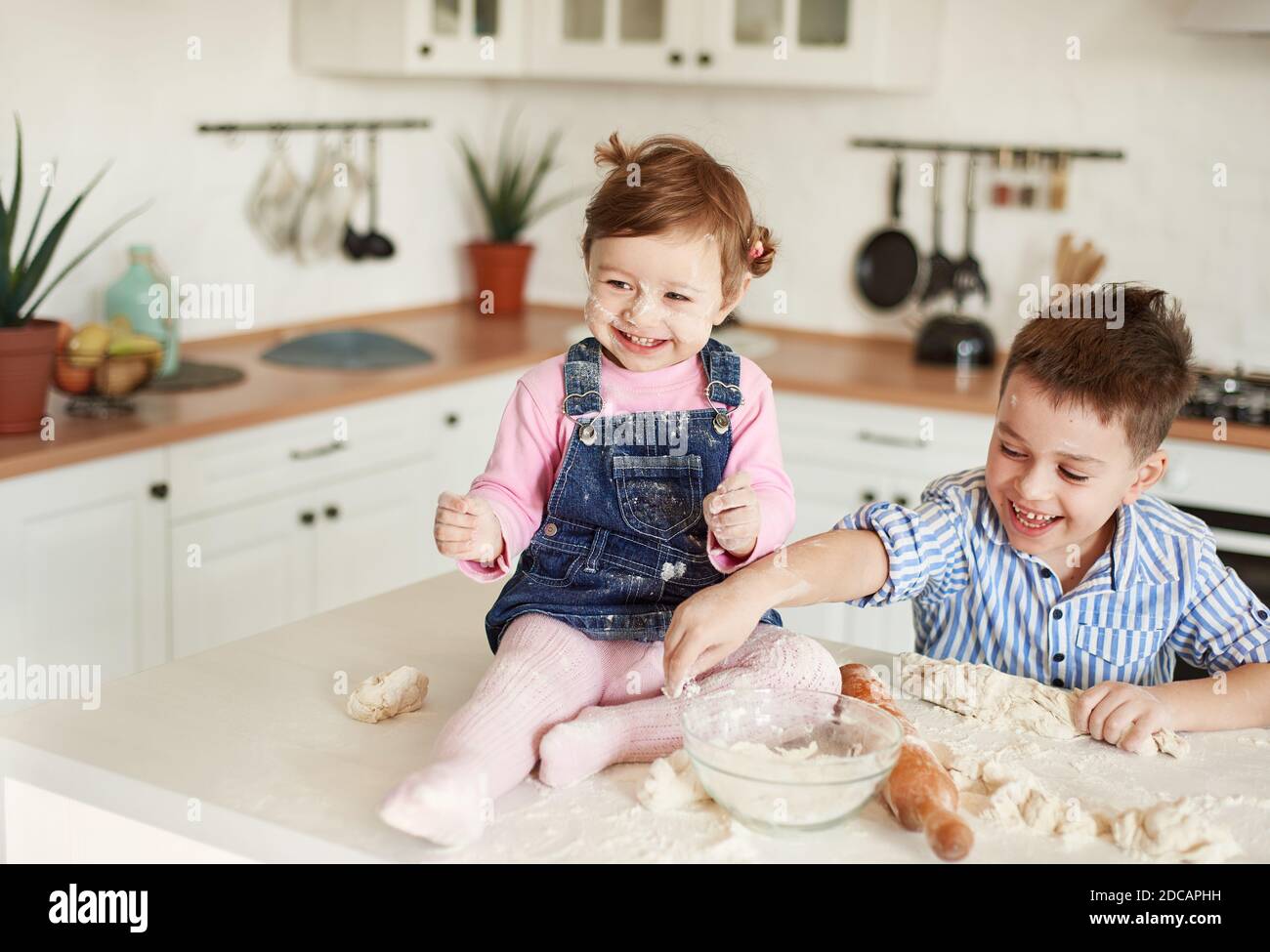 Children laugh, their faces and clothes are soiled in flour Stock Photo ...
