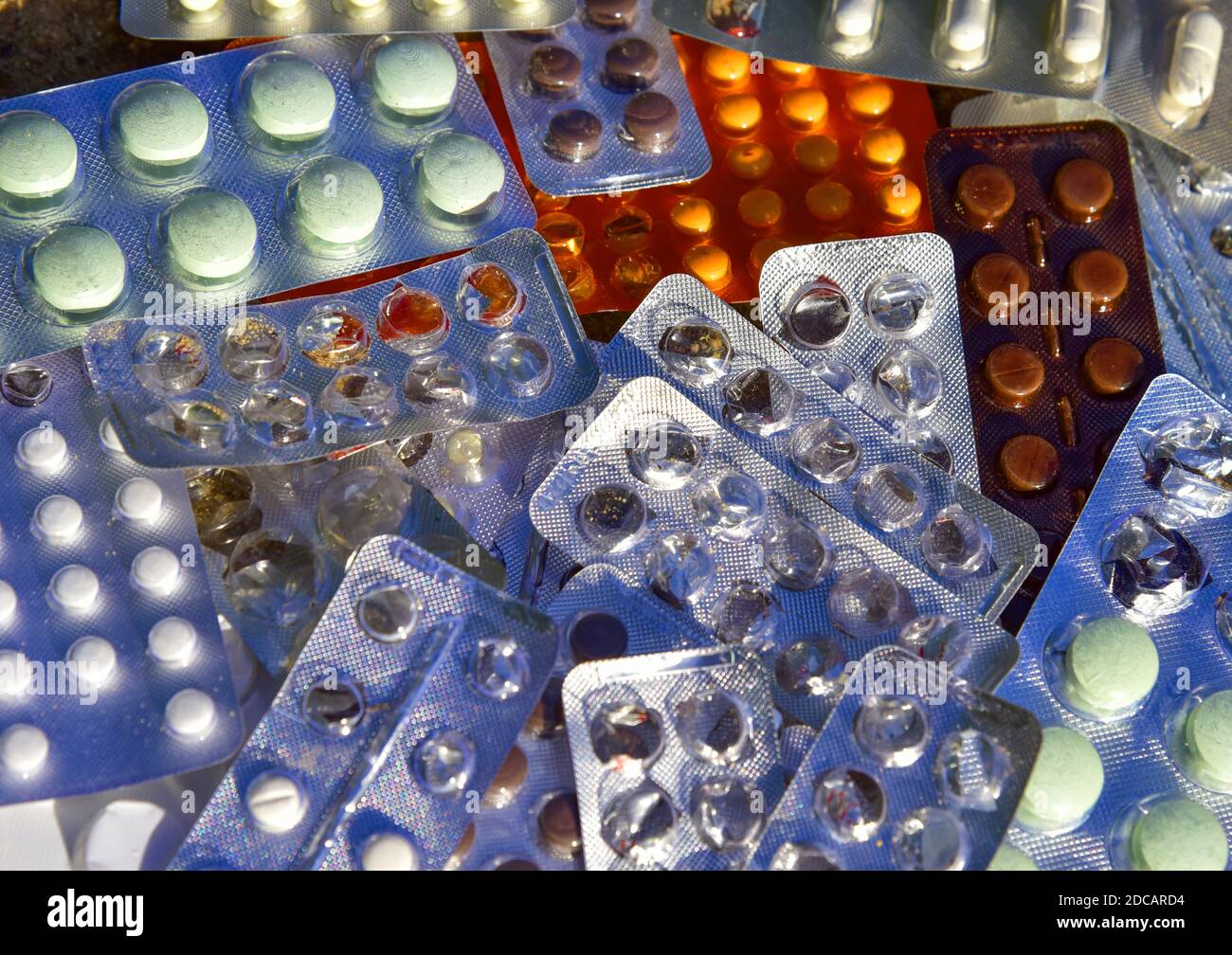Many colorful tablets and medicines drugs in plastic pharmaceutical ...