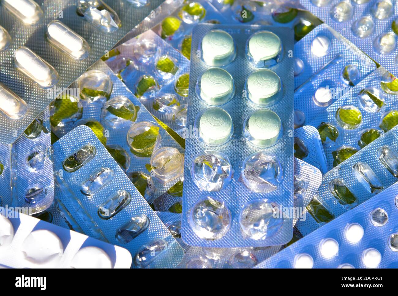 Many colorful tablets and medicines drugs in plastic pharmaceutical ...