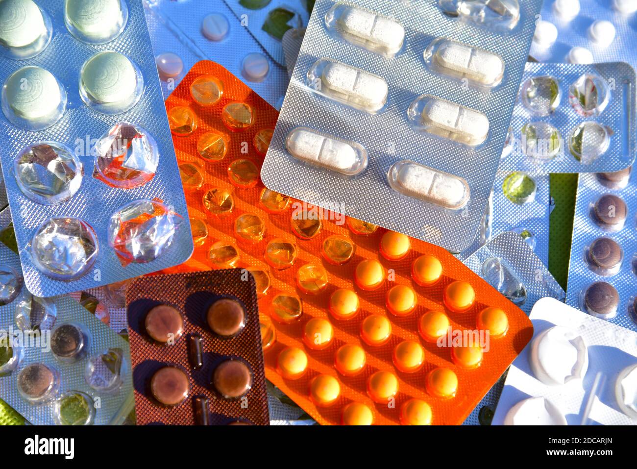Many colorful tablets and medicines drugs in plastic pharmaceutical ...