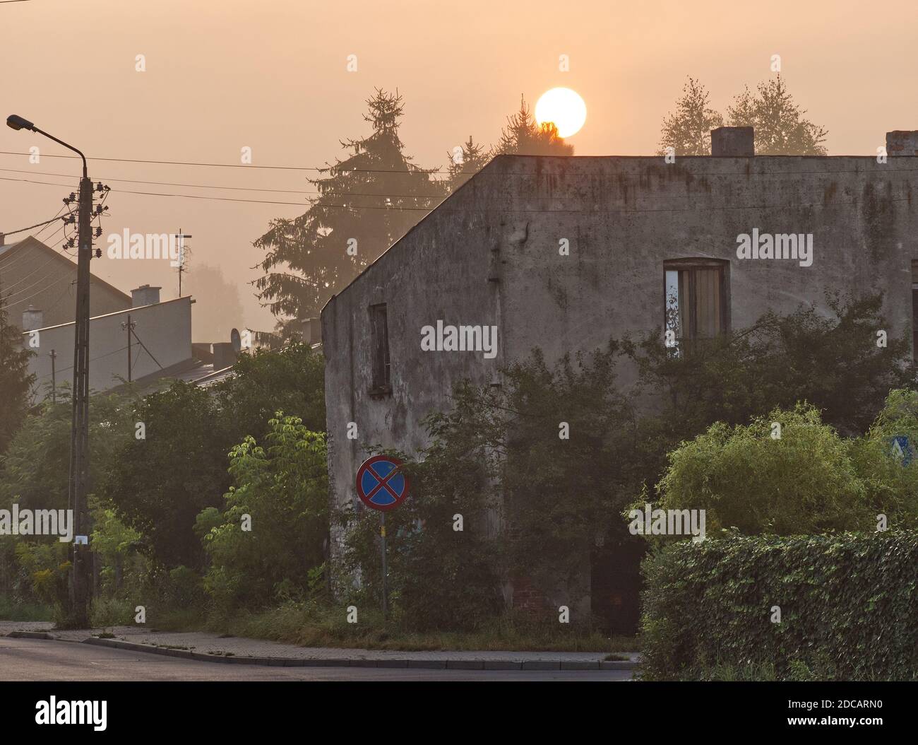 Sunrise over a common house in the morning. With a street and ...