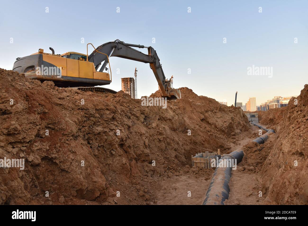 Excavator dig the trenches at a construction site. Trench for laying ...