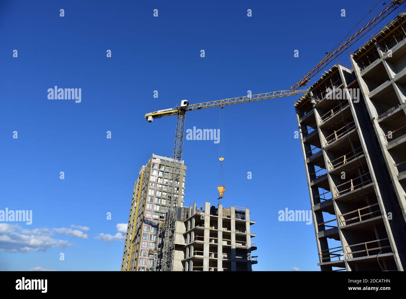 Preparing to pour a bucket of concrete into formwork.Tower crane ...