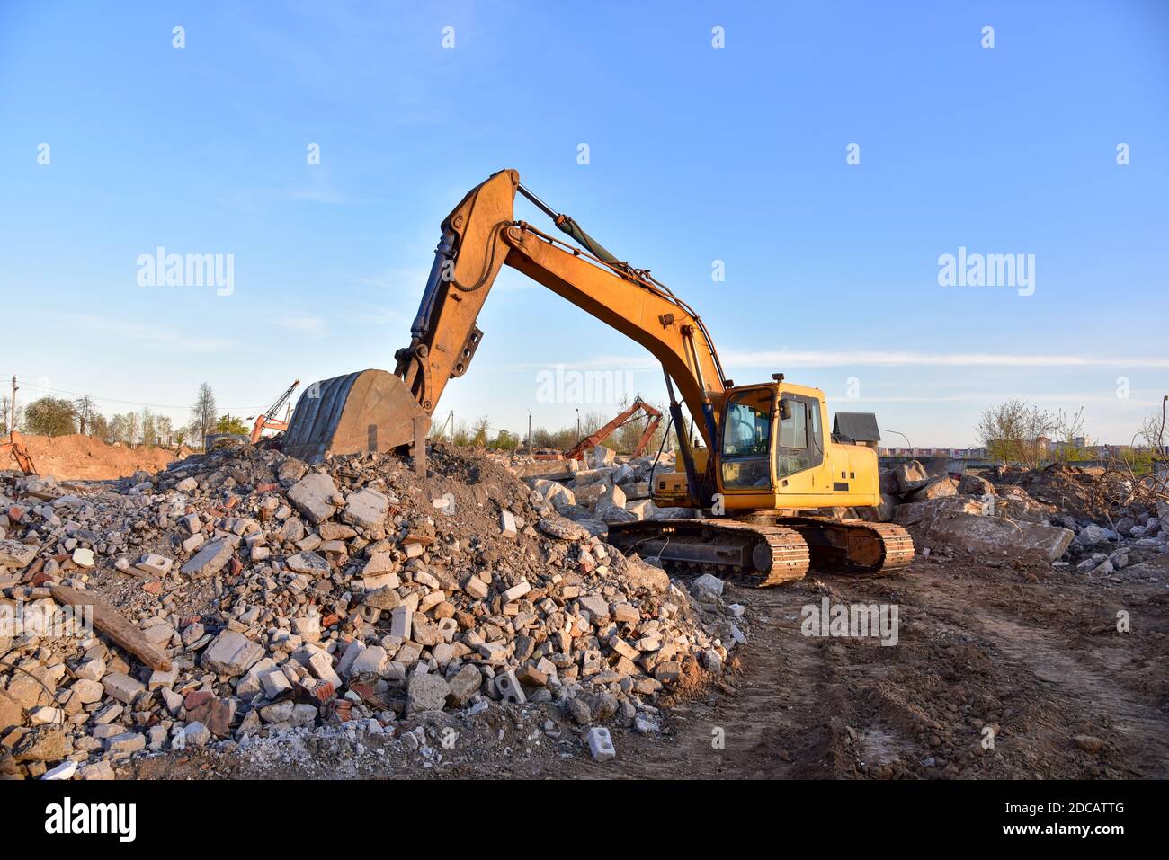 Excavator work at landfill with concrete demolition waste. Salvaging ...