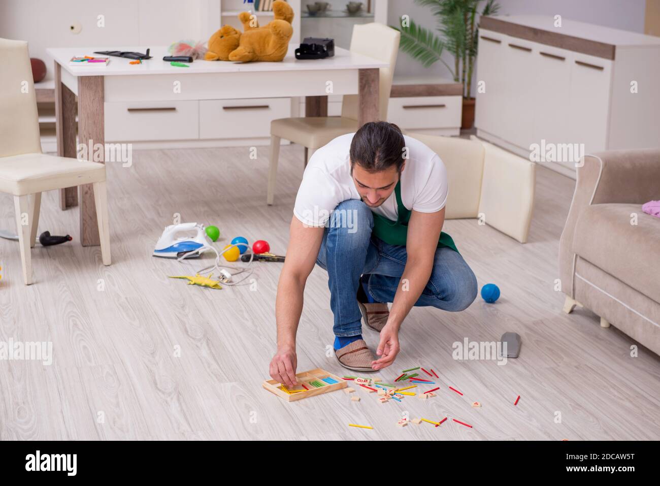 Young contractor cleaning the flat after kids' party Stock Photo - Alamy